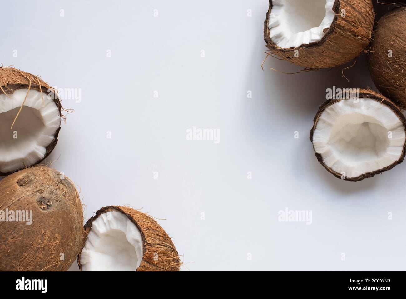 top view of fresh tasty whole coconuts and halves on white background ...