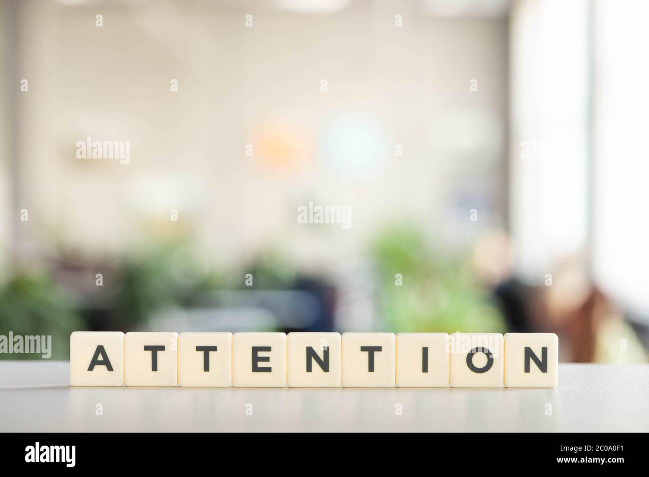 white cubes with attention lettering on white desk Stock Photo - Alamy