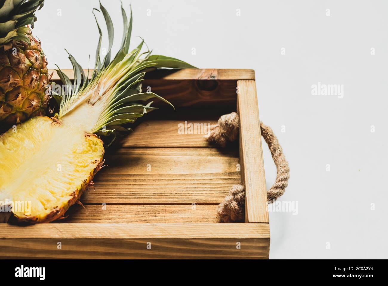 fresh cut pineapple on wooden tray on white background Stock Photo - Alamy