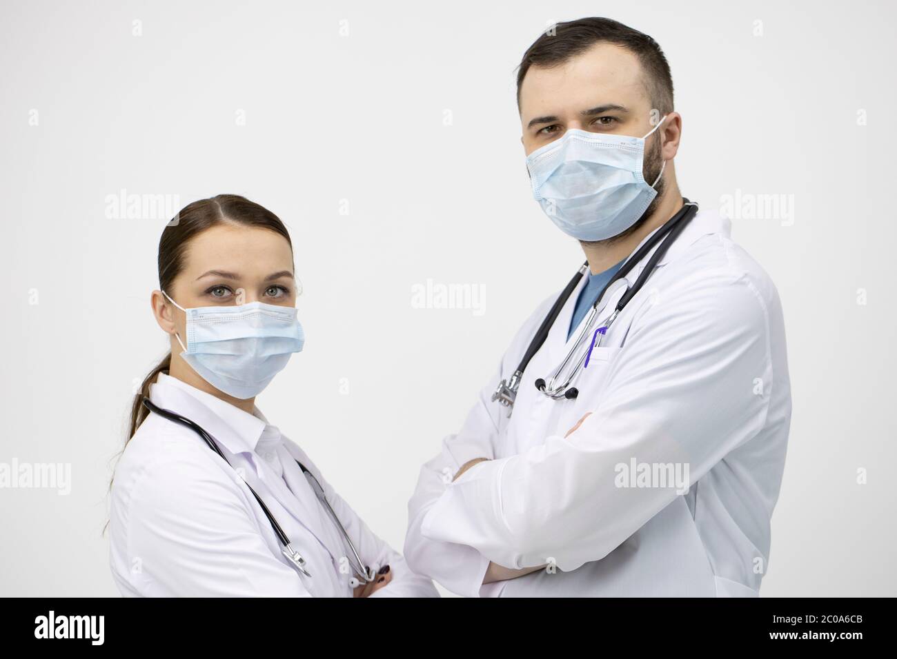 Two doctors in masks looks at camera, healthcare support, medical ...