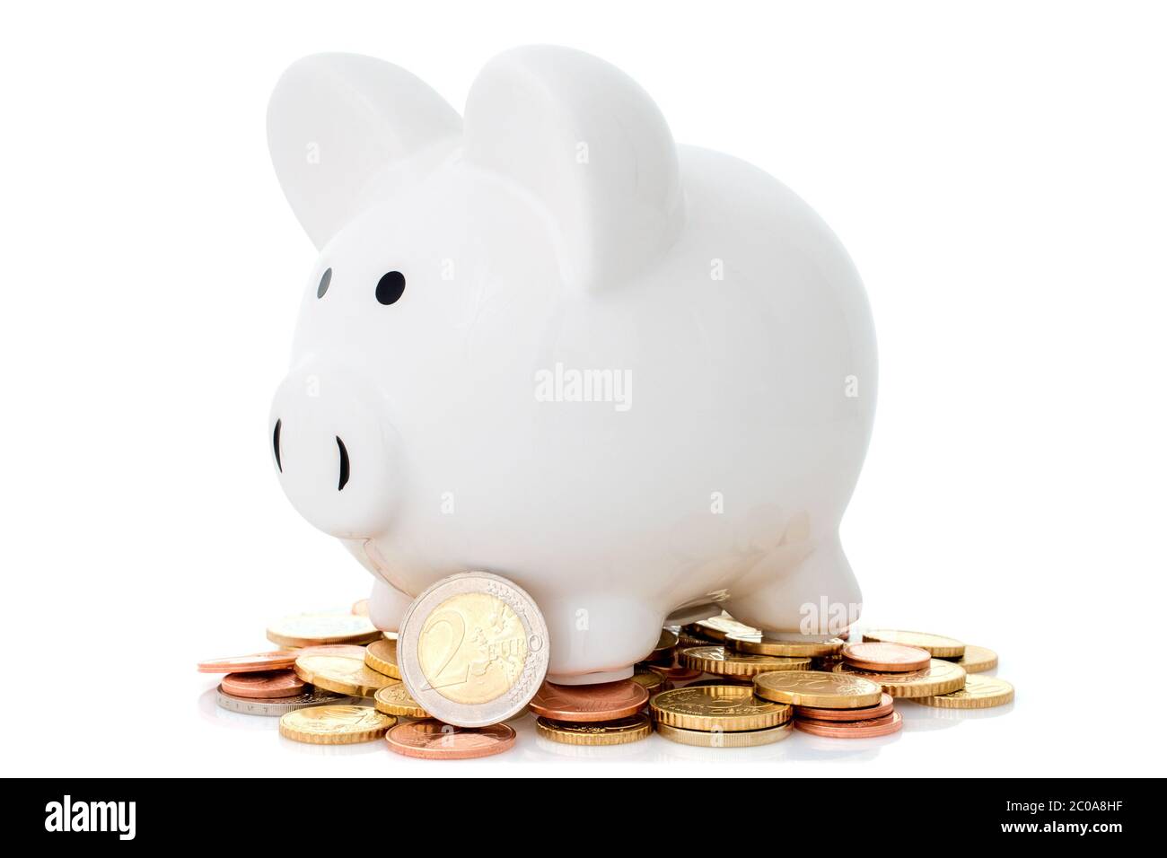Piggy bank and coins pile Stock Photo - Alamy