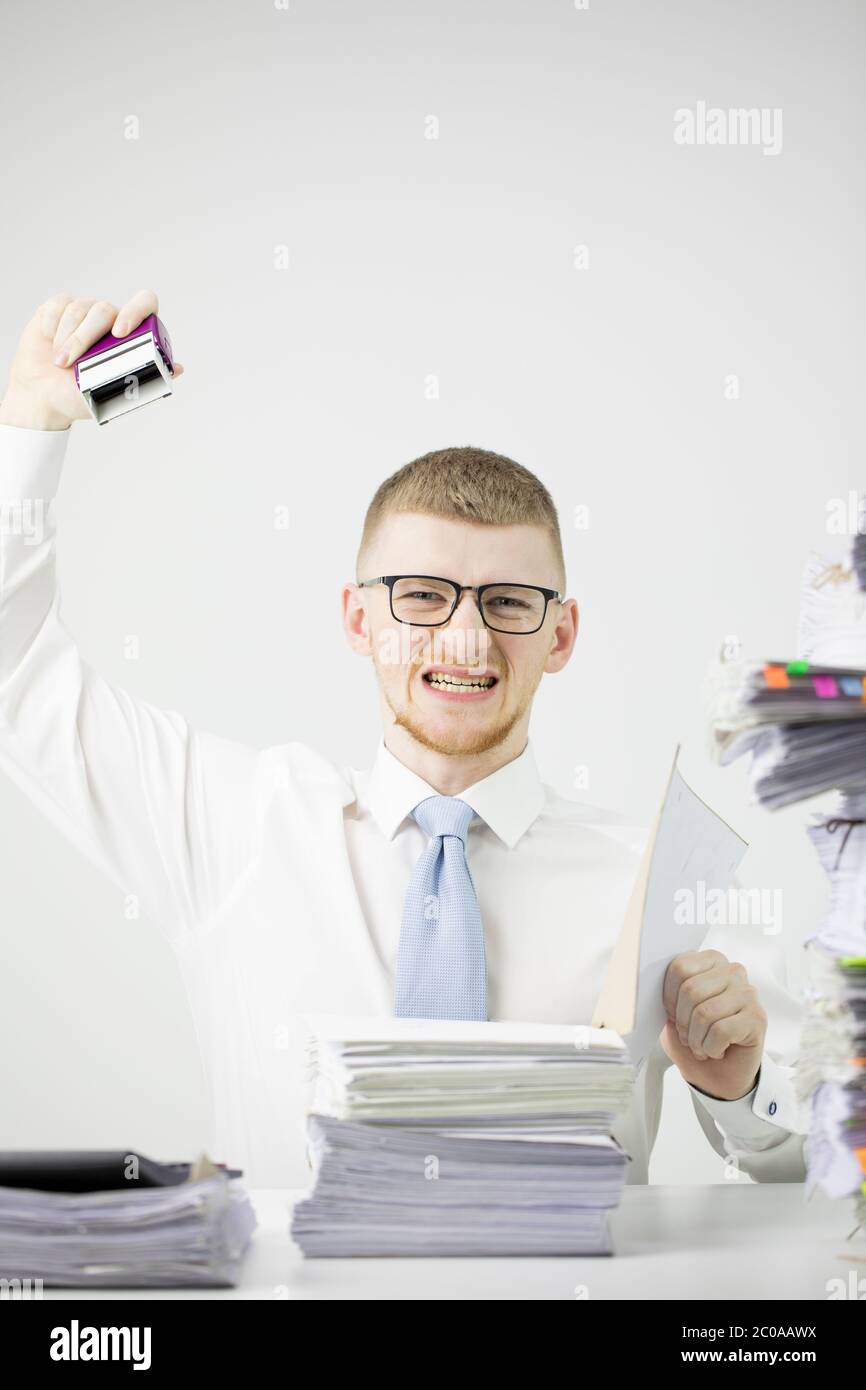 Angry burnout office worker works in chaos among piles of paperwork ...