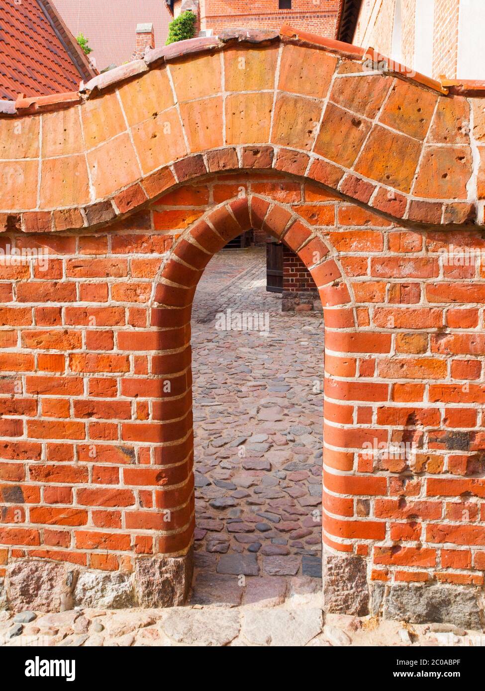Small ancient brick gate on the castle Stock Photo - Alamy