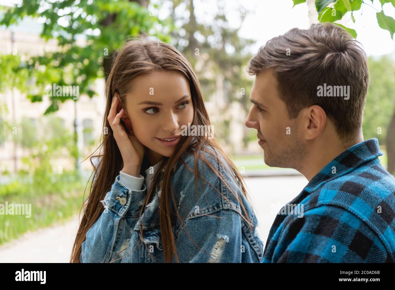 pretty girl touching hair while flirting with boyfriend Stock Photo - Alamy