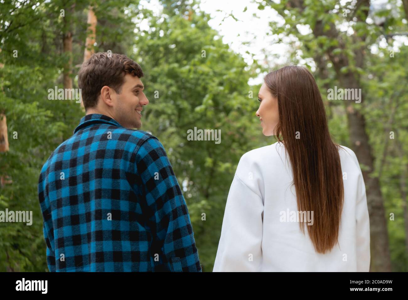 handsome boyfriend and girlfriend looking at each other in park Stock ...