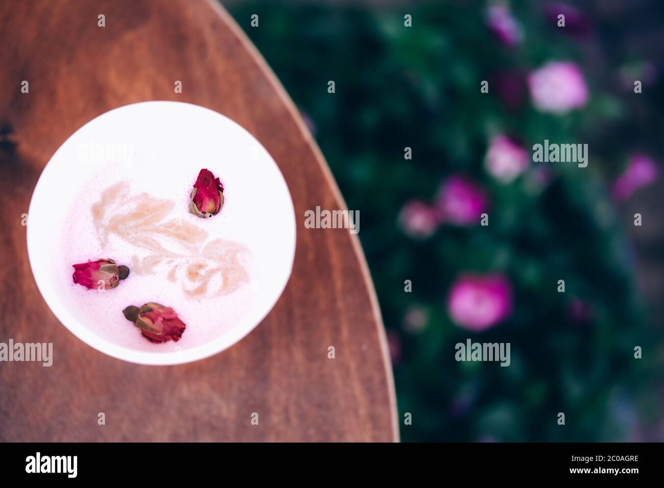 Rose beetroot takeout latte coffee with vegan coconut milk on wooden ...