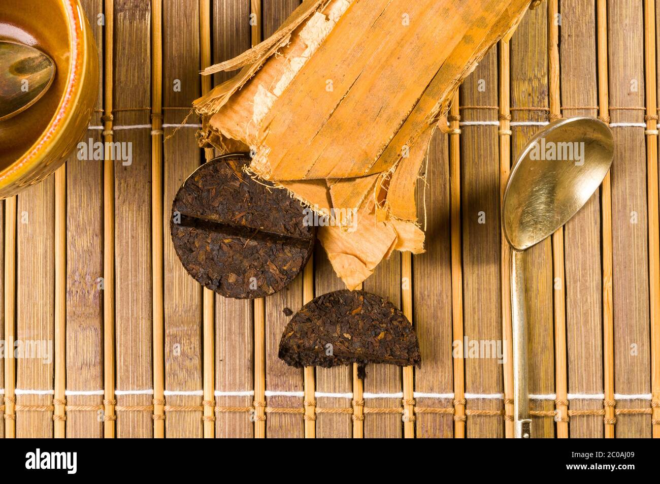 Chinese pressed PU-erh tea in bamboo leaf packaging and tea accessories ...