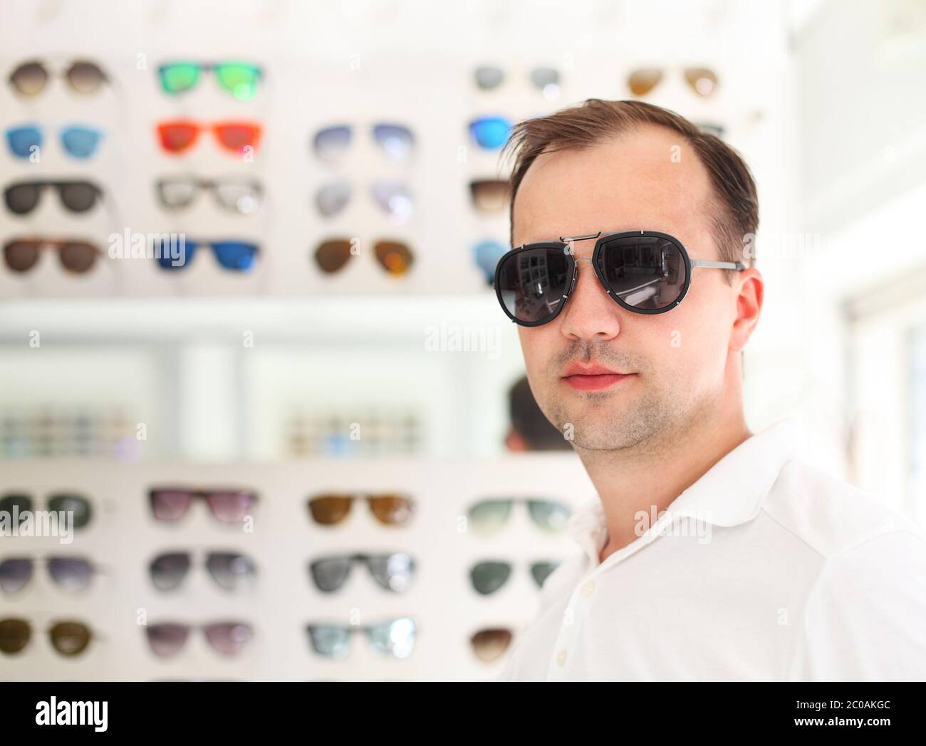 Man trying on new sunglasses Stock Photo - Alamy