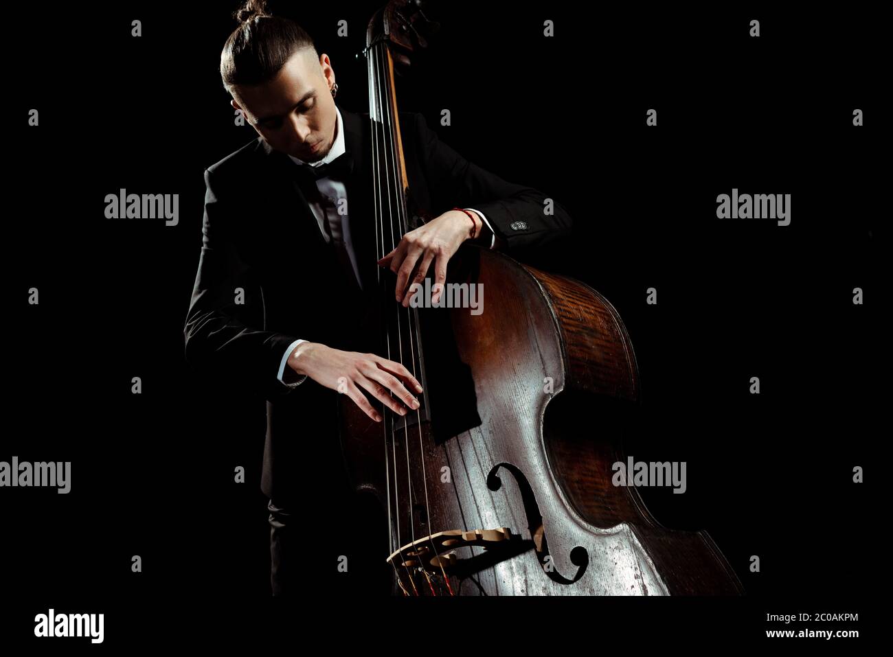 male musician playing on contrabass isolated on black Stock Photo - Alamy