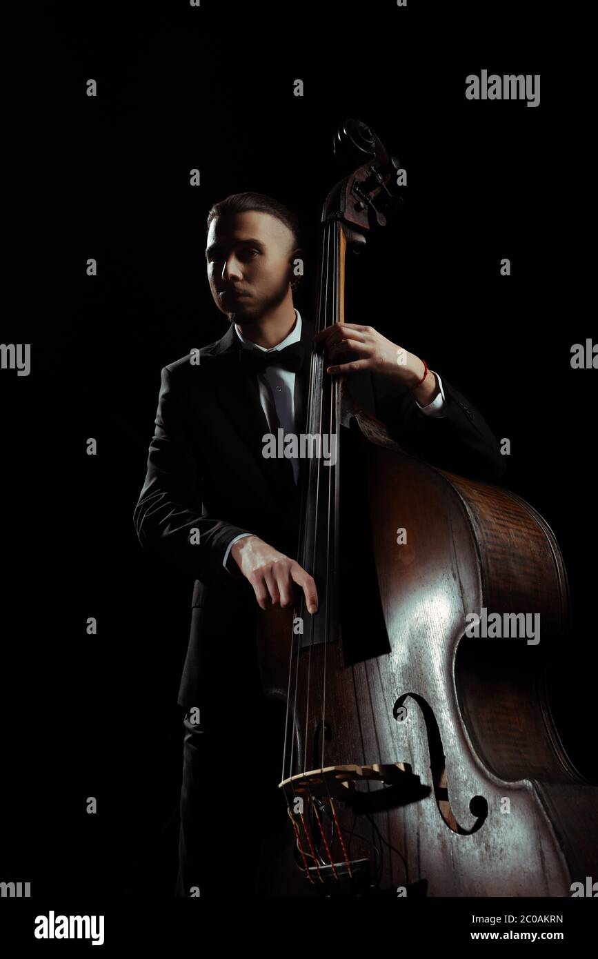 professional musician playing on contrabass isolated on black Stock ...