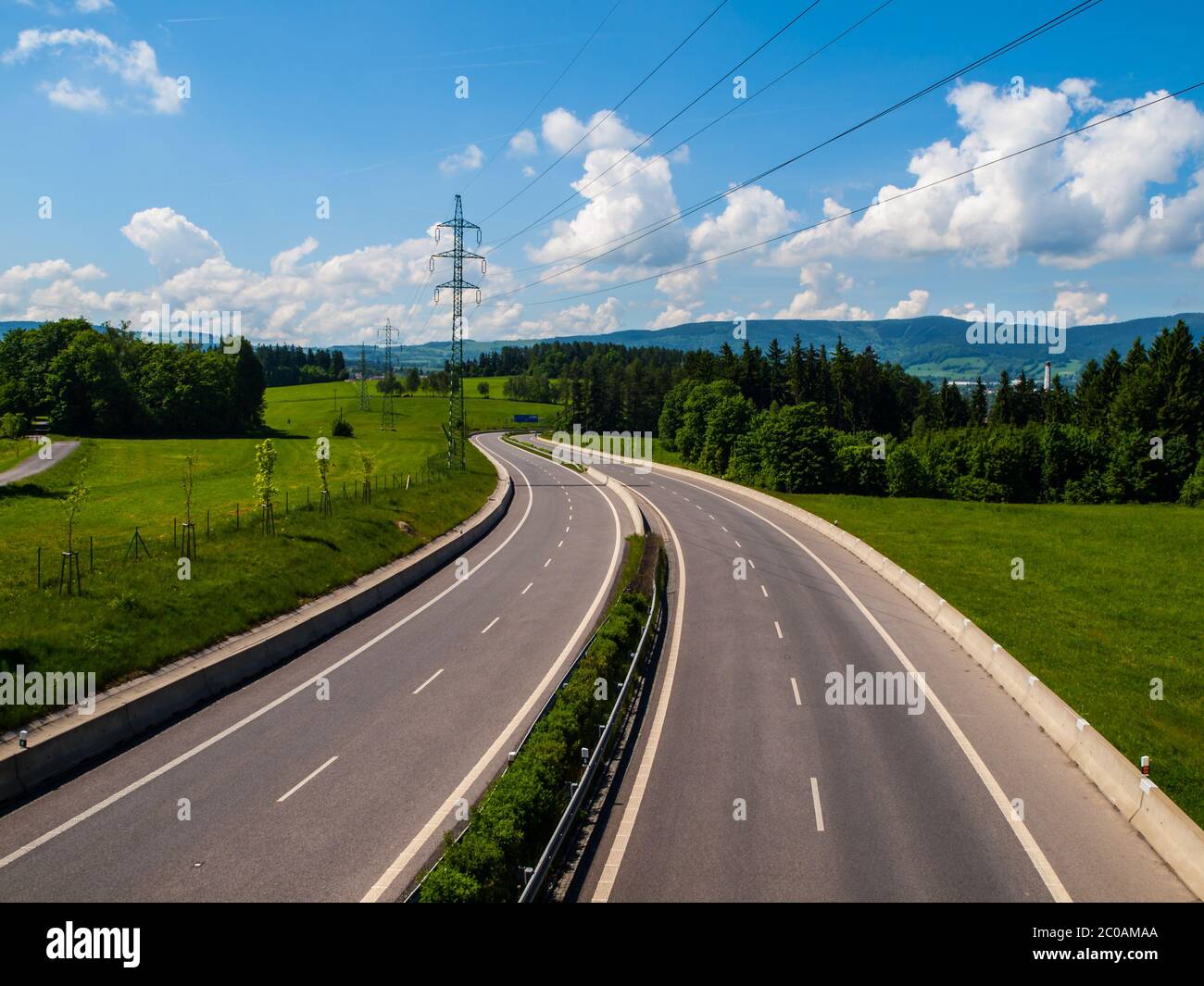 Two line wide highway with curve in sunny day Stock Photo - Alamy