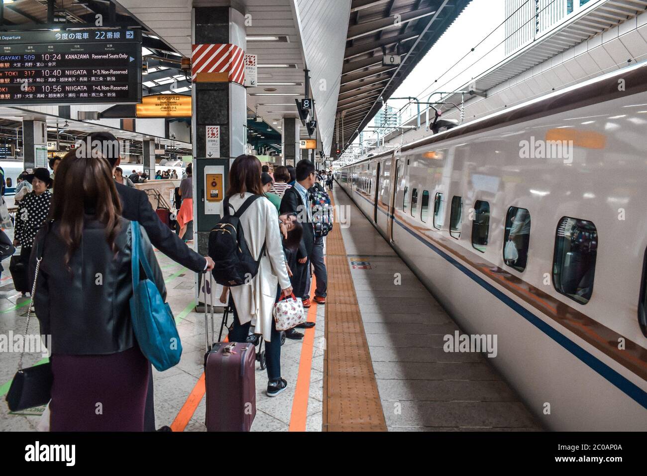 People waiting for Shinkansen bullet train on a platform in Tokyo Japan Stock Photo - Alamy