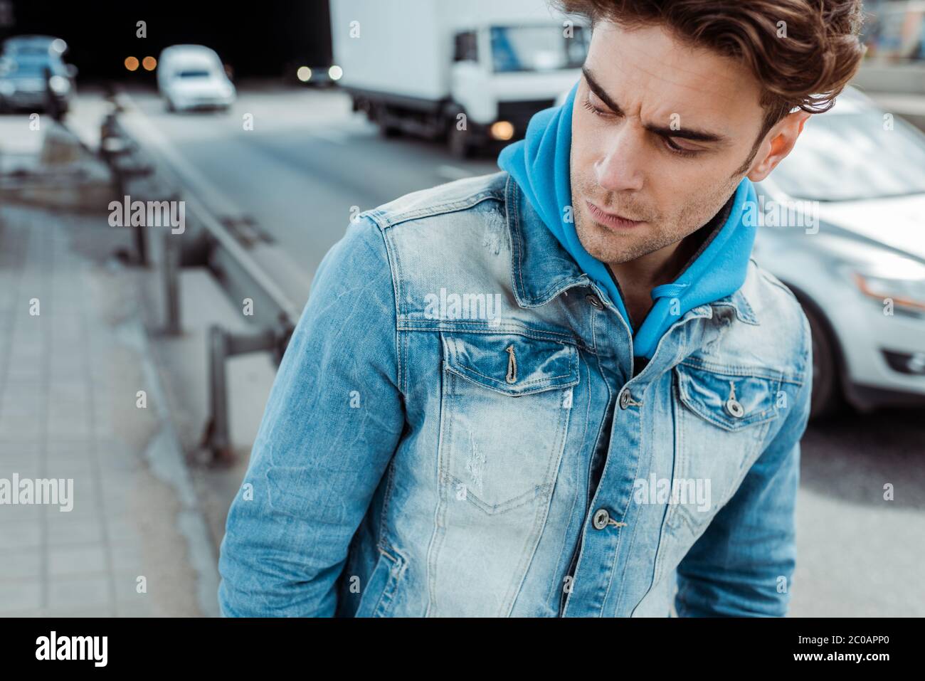 Sad man walking near road at background Stock Photo - Alamy