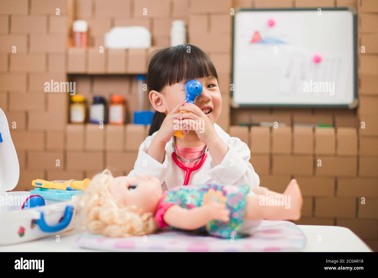 toddler girl pretend play doctor role at home Stock Photo - Alamy