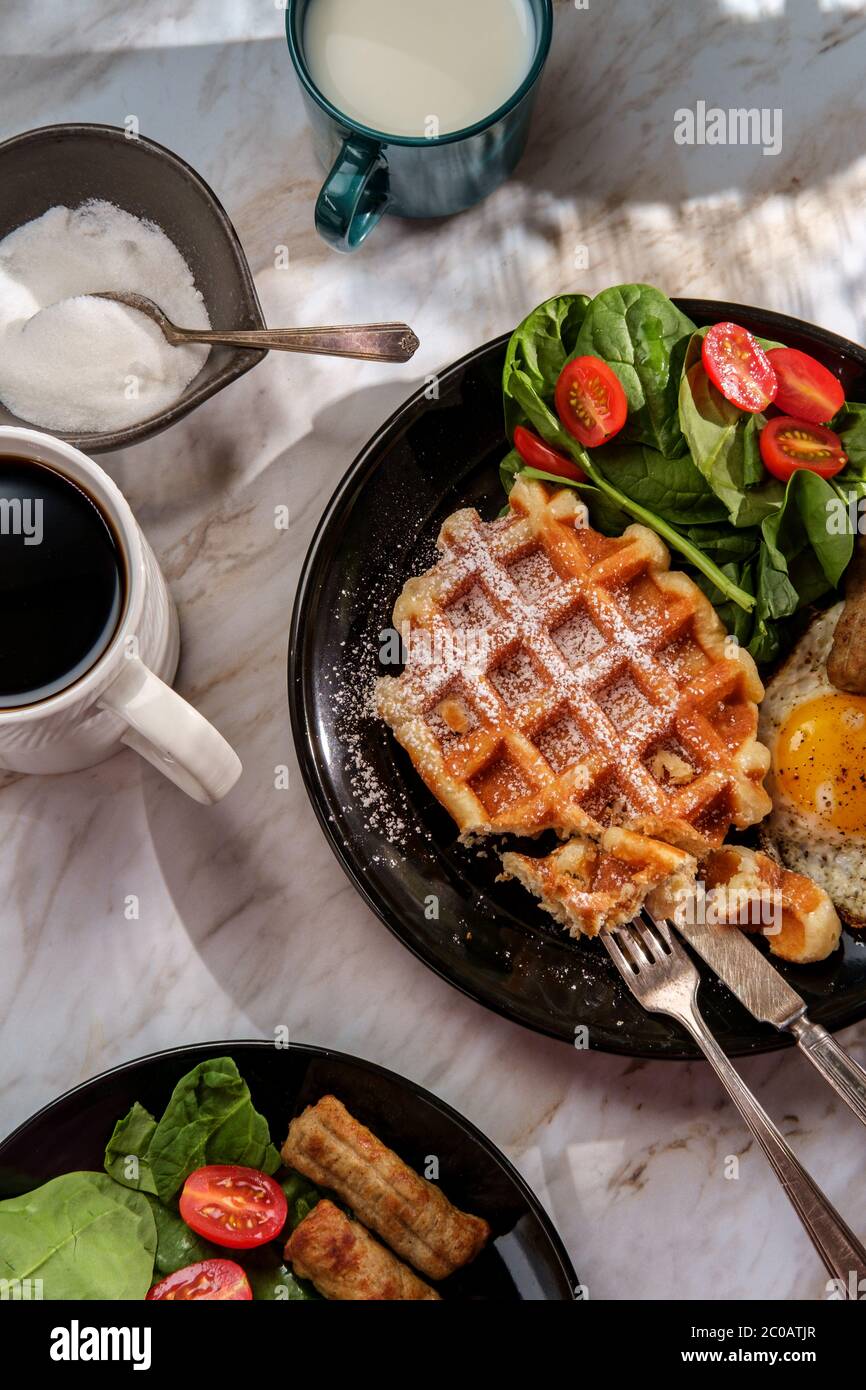Belgian waffle breakfast served with sausage eggs and coffee Stock ...
