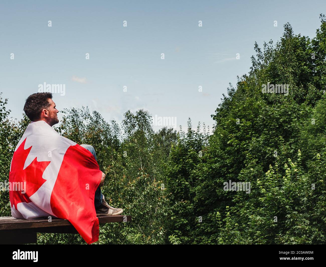 Attractive man holding Canadian Flag. National holiday Stock Photo - Alamy
