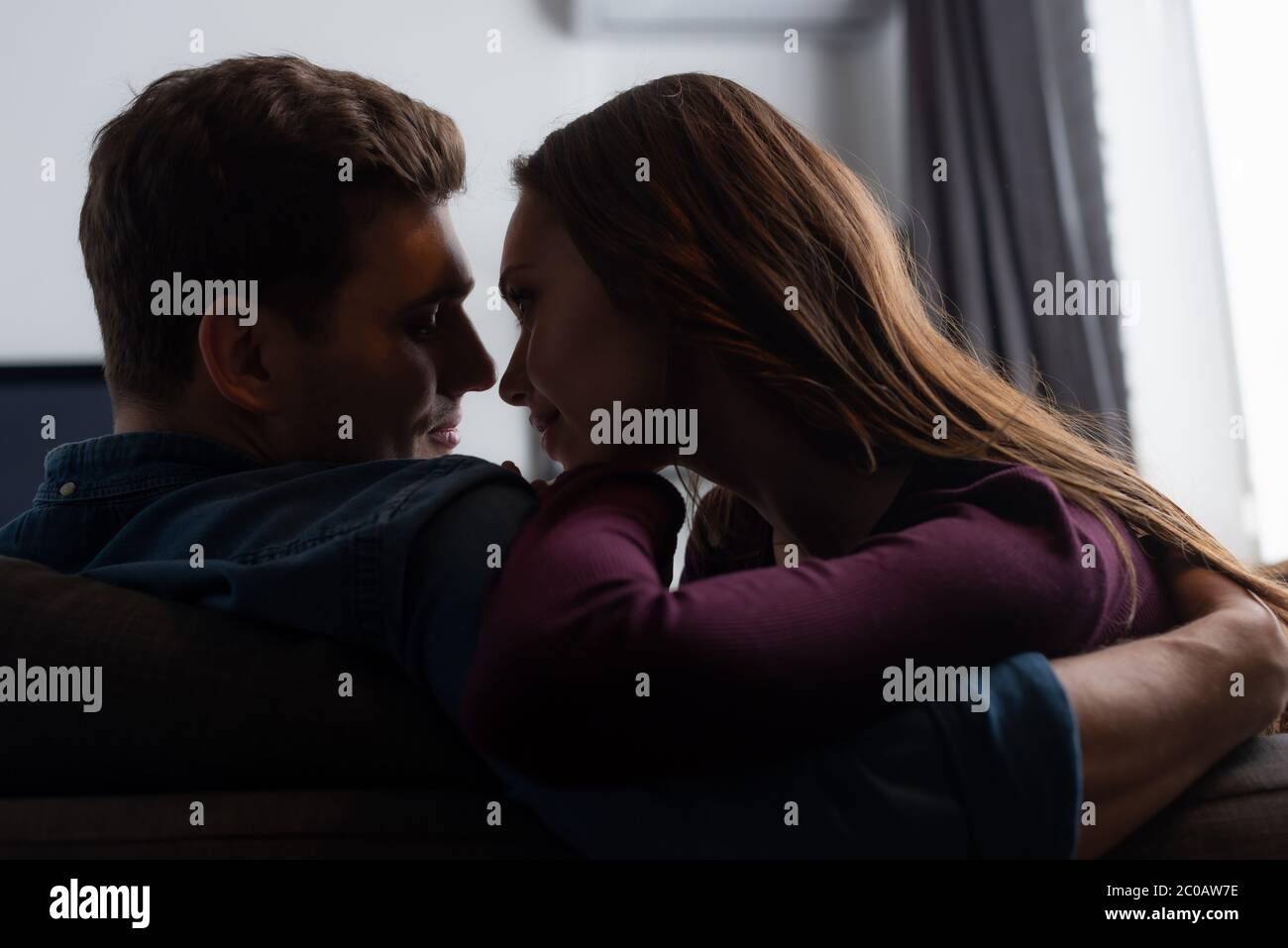 side view of man and woman in living room Stock Photo - Alamy