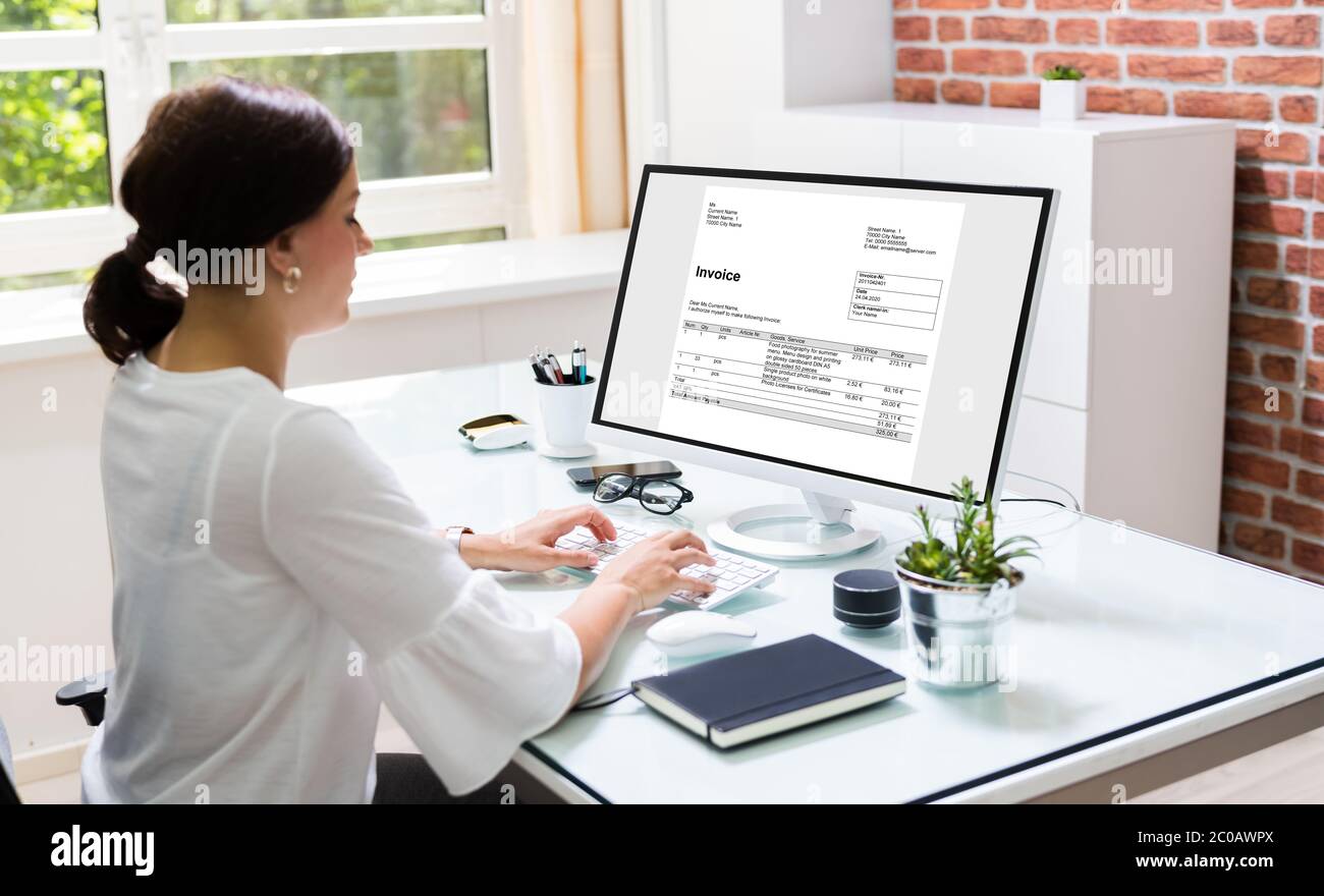 Young Woman Doing Online Invoice Management And Audit Stock Photo - Alamy