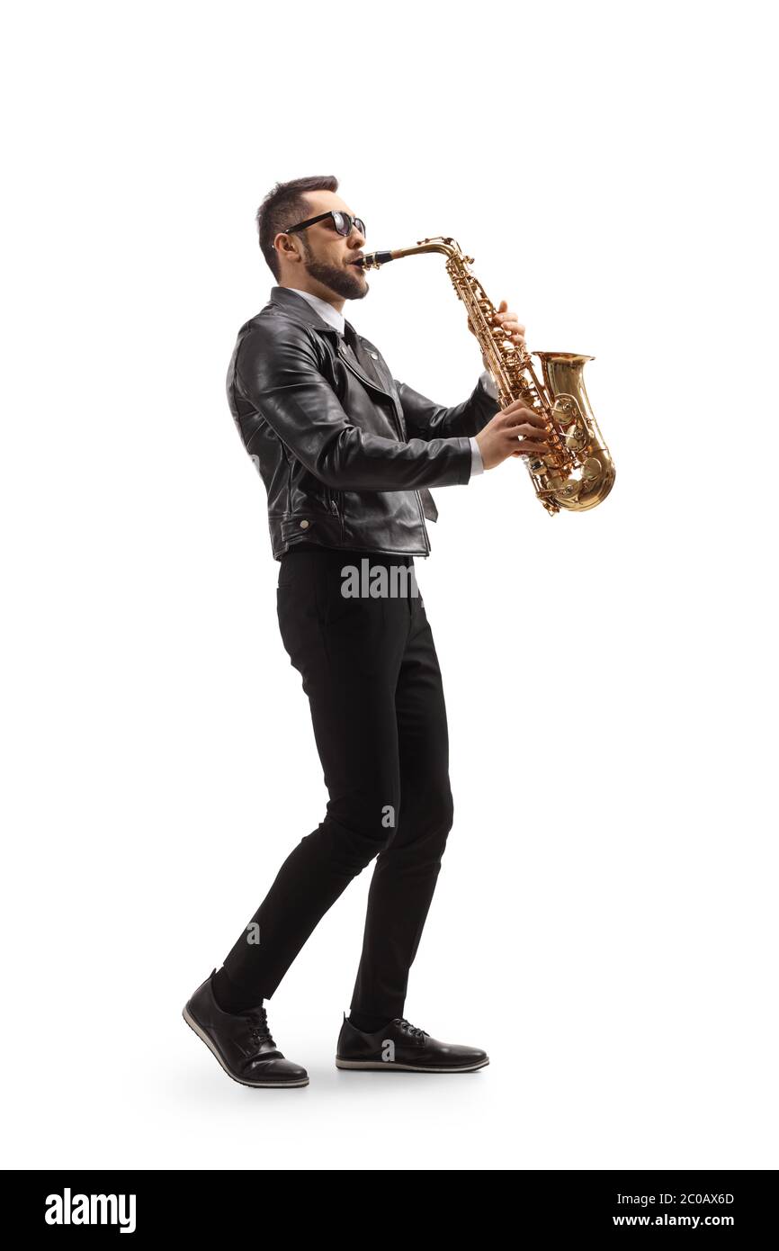 Full length profile shot of a young handsome man playing a saxophone ...