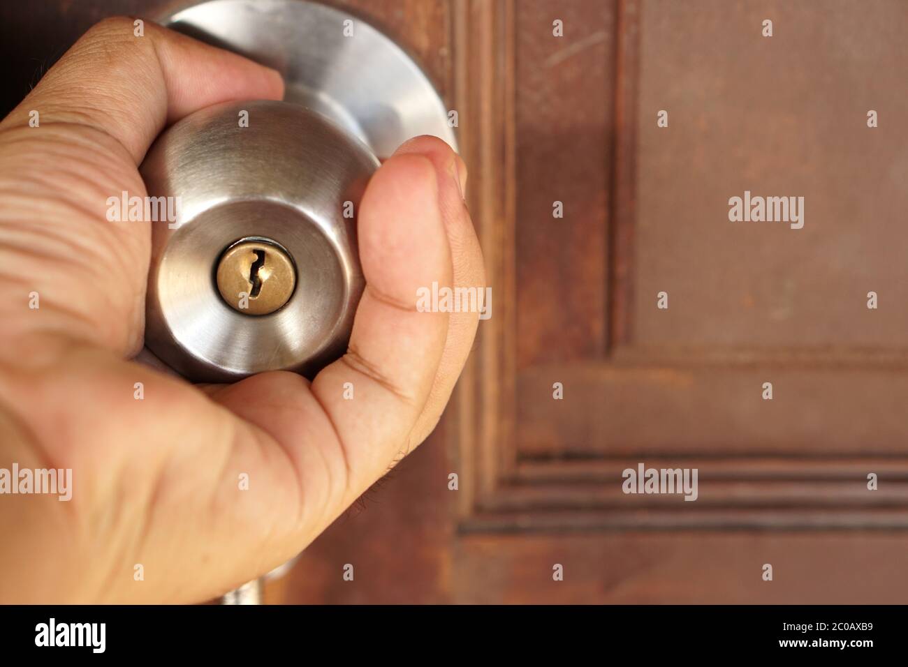 Human hand holding doorknob hi-res stock photography and images - Alamy