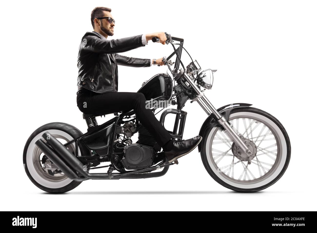 Profile shot of a biker on a custom chopper riding with sunglasses ...