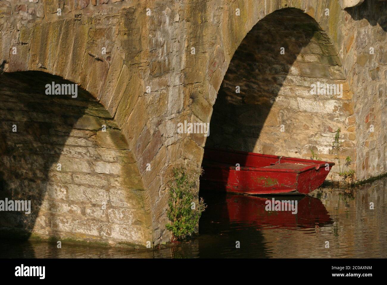 Red rowing boat under a bridge Stock Photo - Alamy