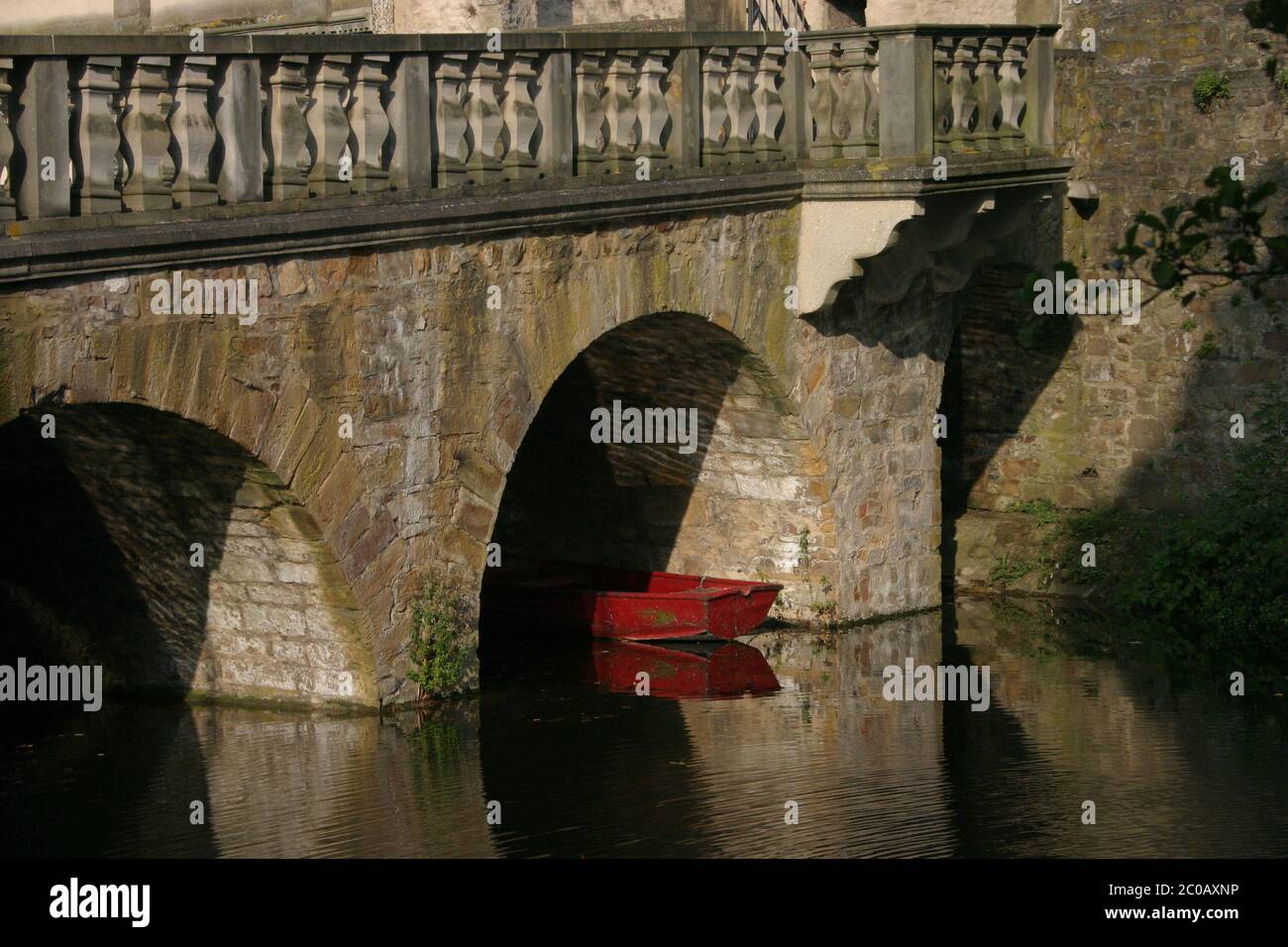 Red rowing boat under a bridge Stock Photo - Alamy
