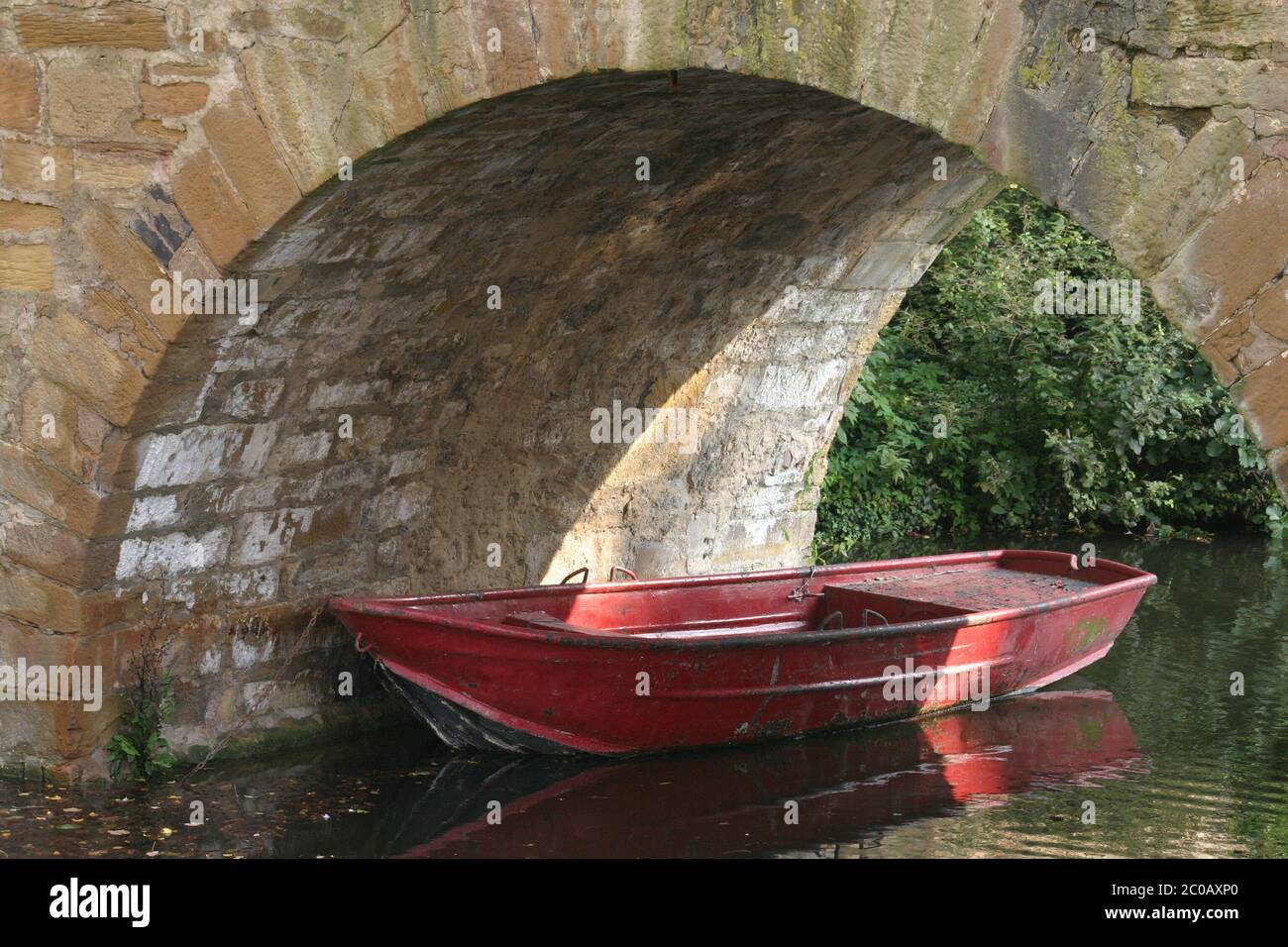 Red rowing boat under a bridge Stock Photo - Alamy