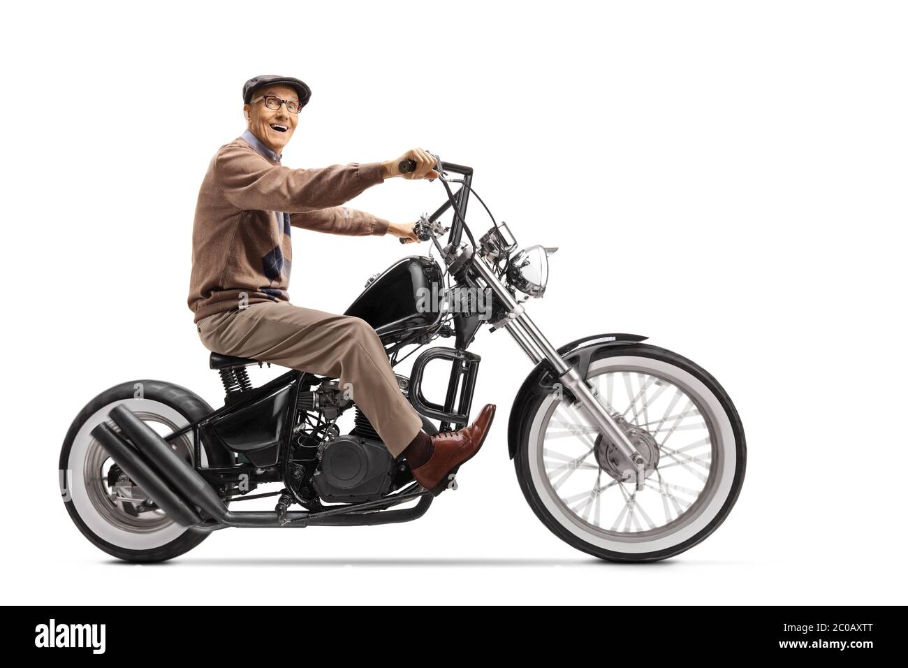 Elderly man riding a custom chopper motorbike and smiling at the camera ...