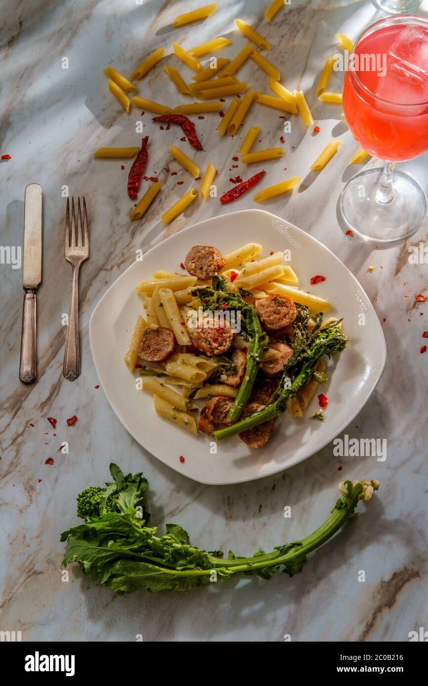 Italian spicy sausage penne pasta and broccoli rabe with dramatic ...