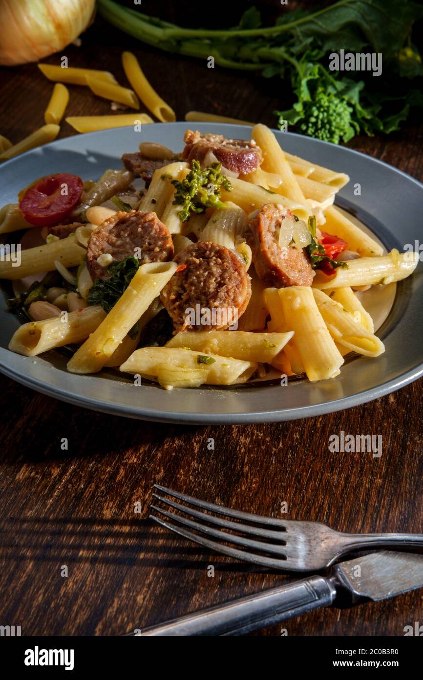 Italian spicy sausage penne pasta and broccoli rabe with dramatic ...
