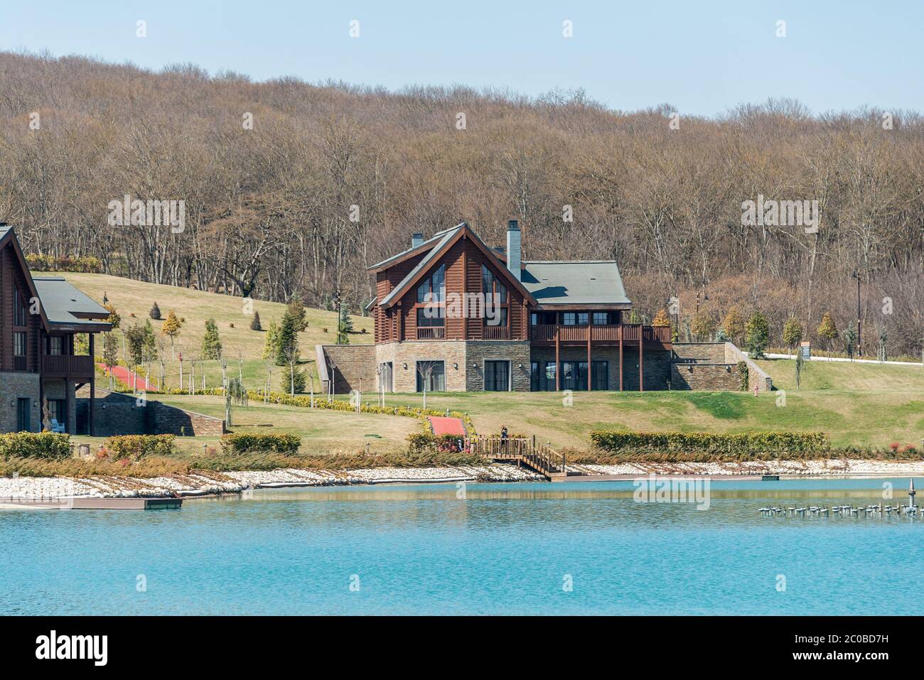 Modern house near water on bright day Stock Photo - Alamy