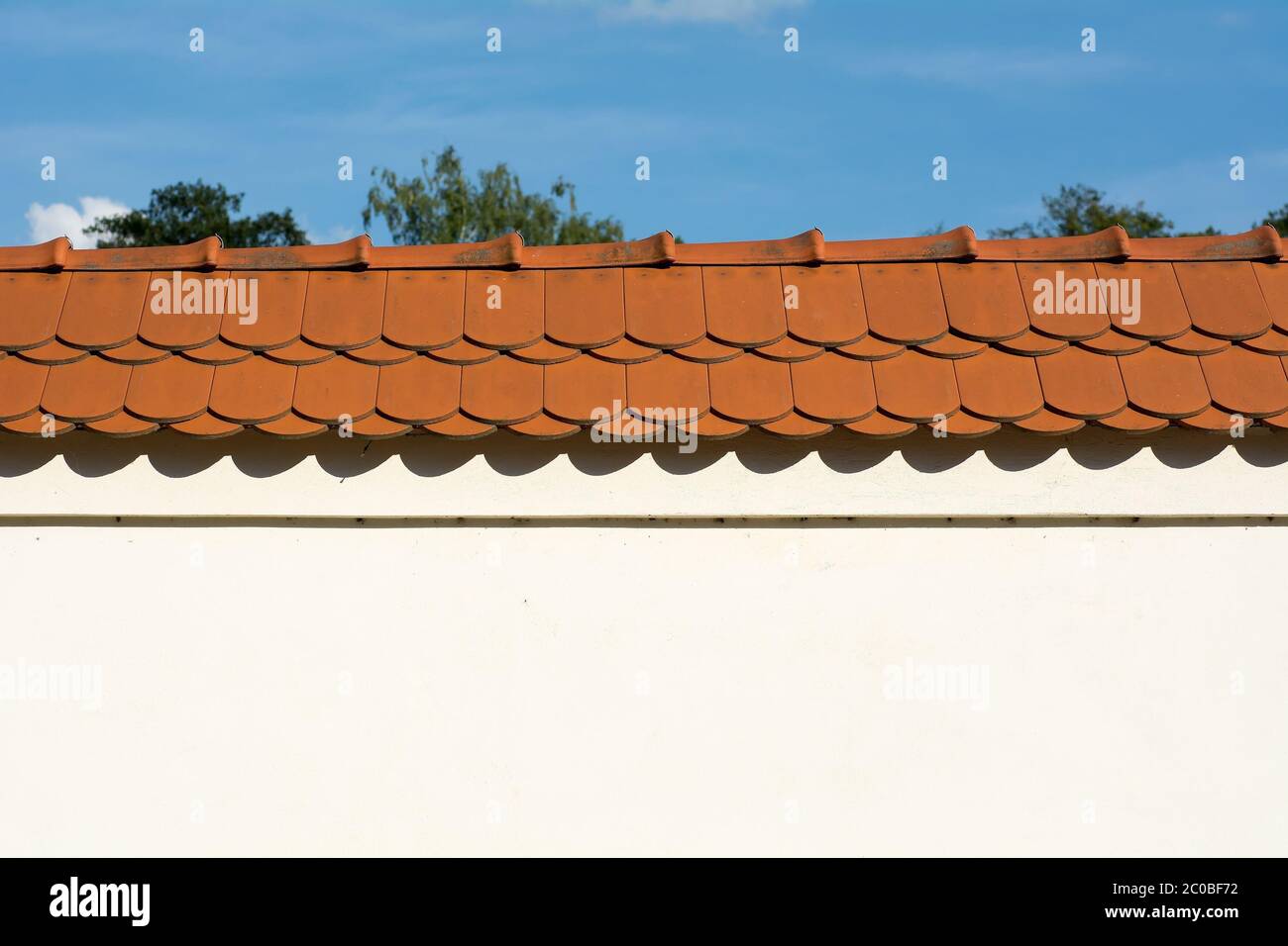 Wall with red roof Stock Photo - Alamy