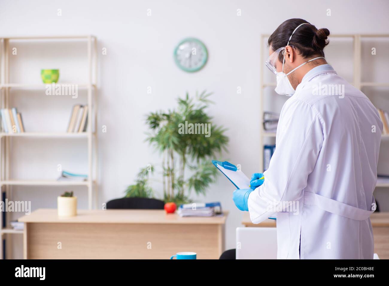 Back view doctor in protective hi-res stock photography and images - Alamy