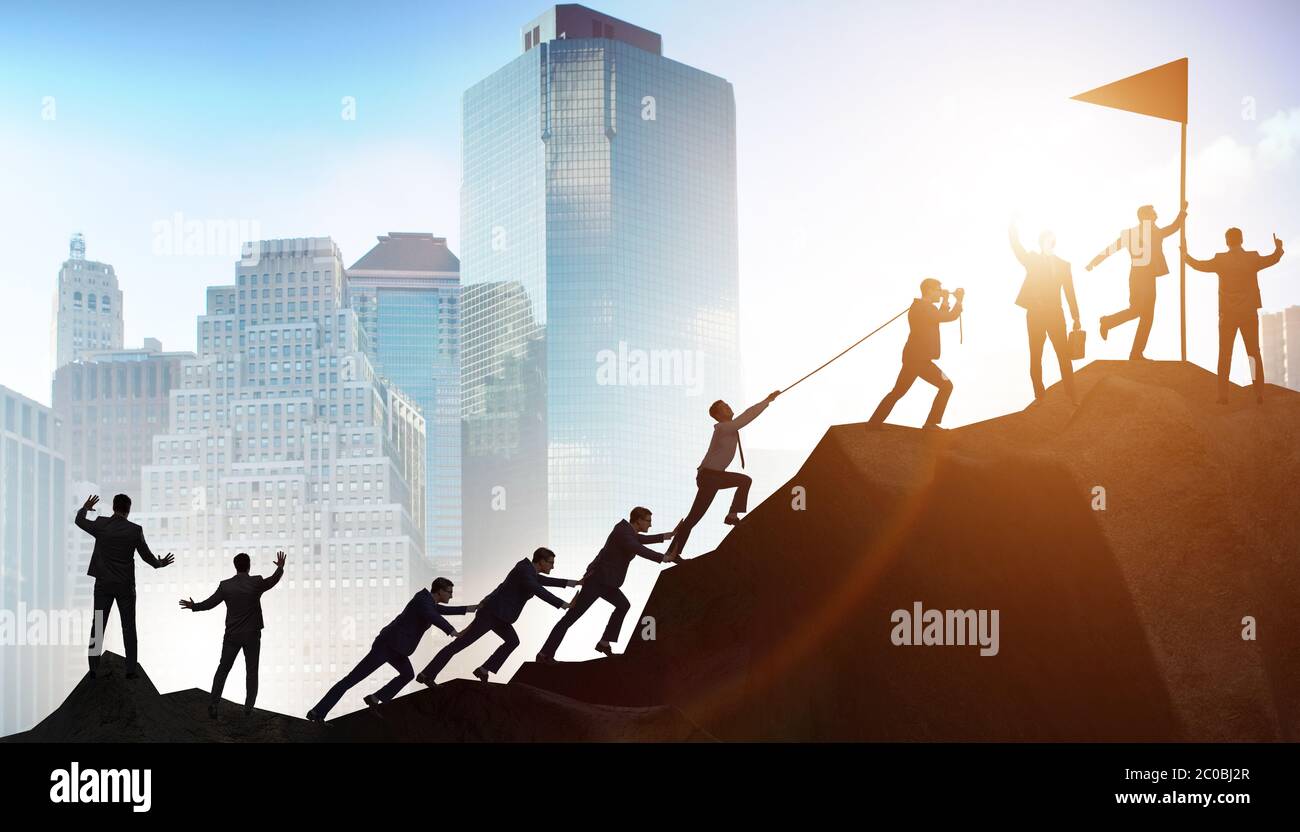 Concept of teamwork with team climbing mountain Stock Photo - Alamy