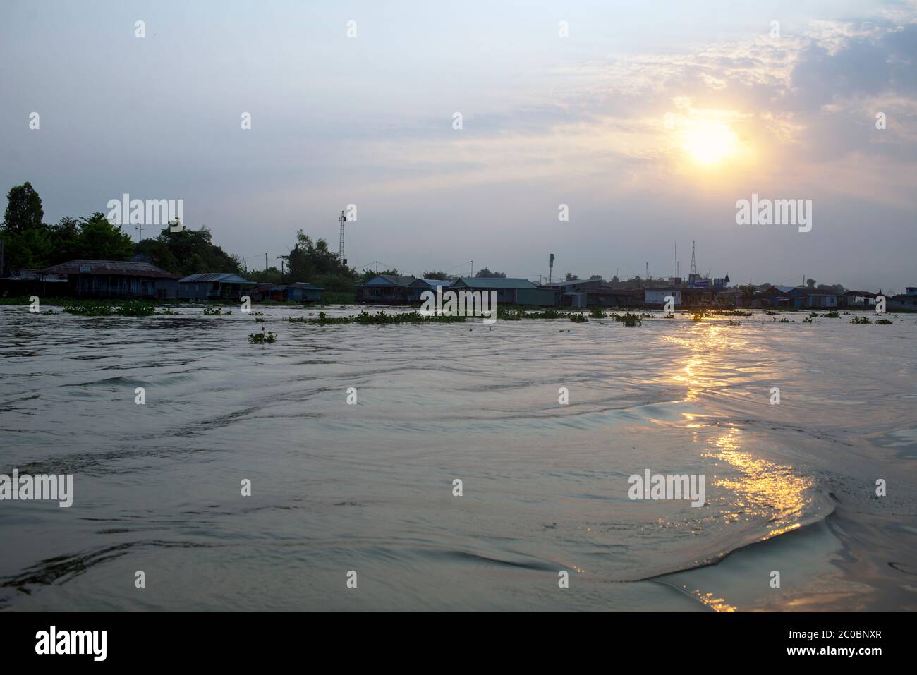 Houses on the Mekong River at sunrise in Chau Doc, Mekong Delta region ...
