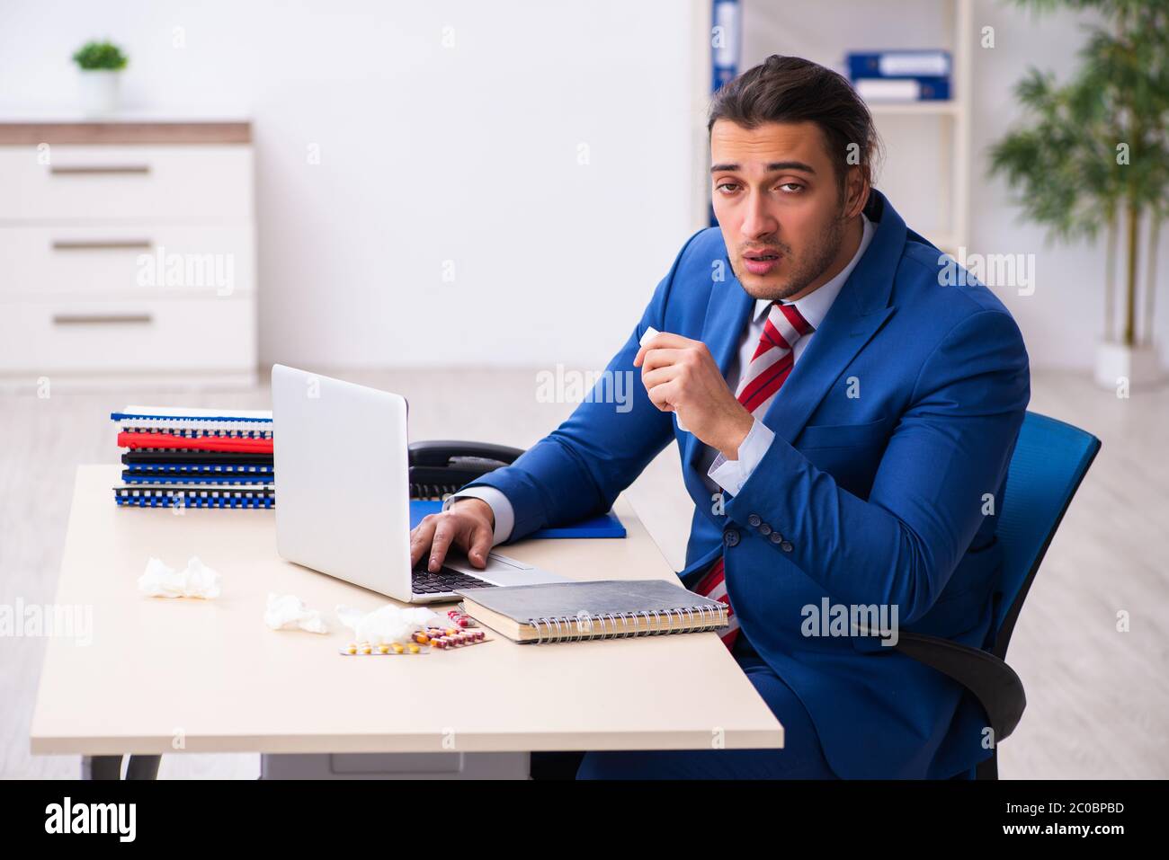 Sick employee suffering at workplace from covid-19 Stock Photo - Alamy