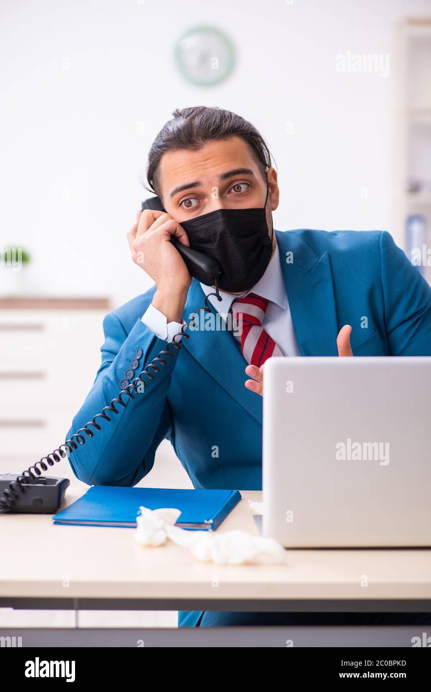 Sick employee suffering at workplace from covid-19 Stock Photo - Alamy