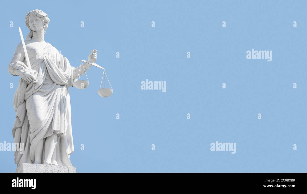 Statue a judge woman with scales and sword at blue sky in Potsdam ...