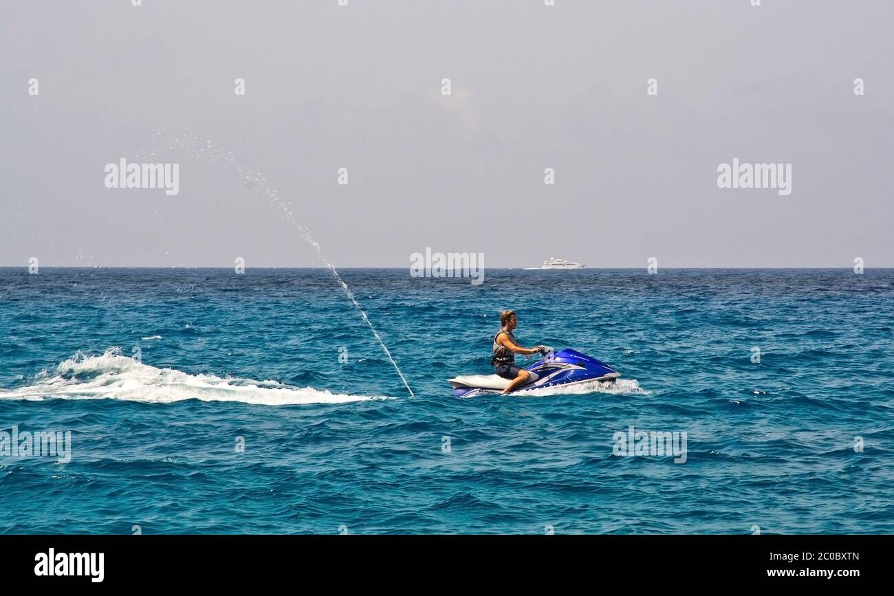 Jetskier with jet spraying Stock Photo - Alamy