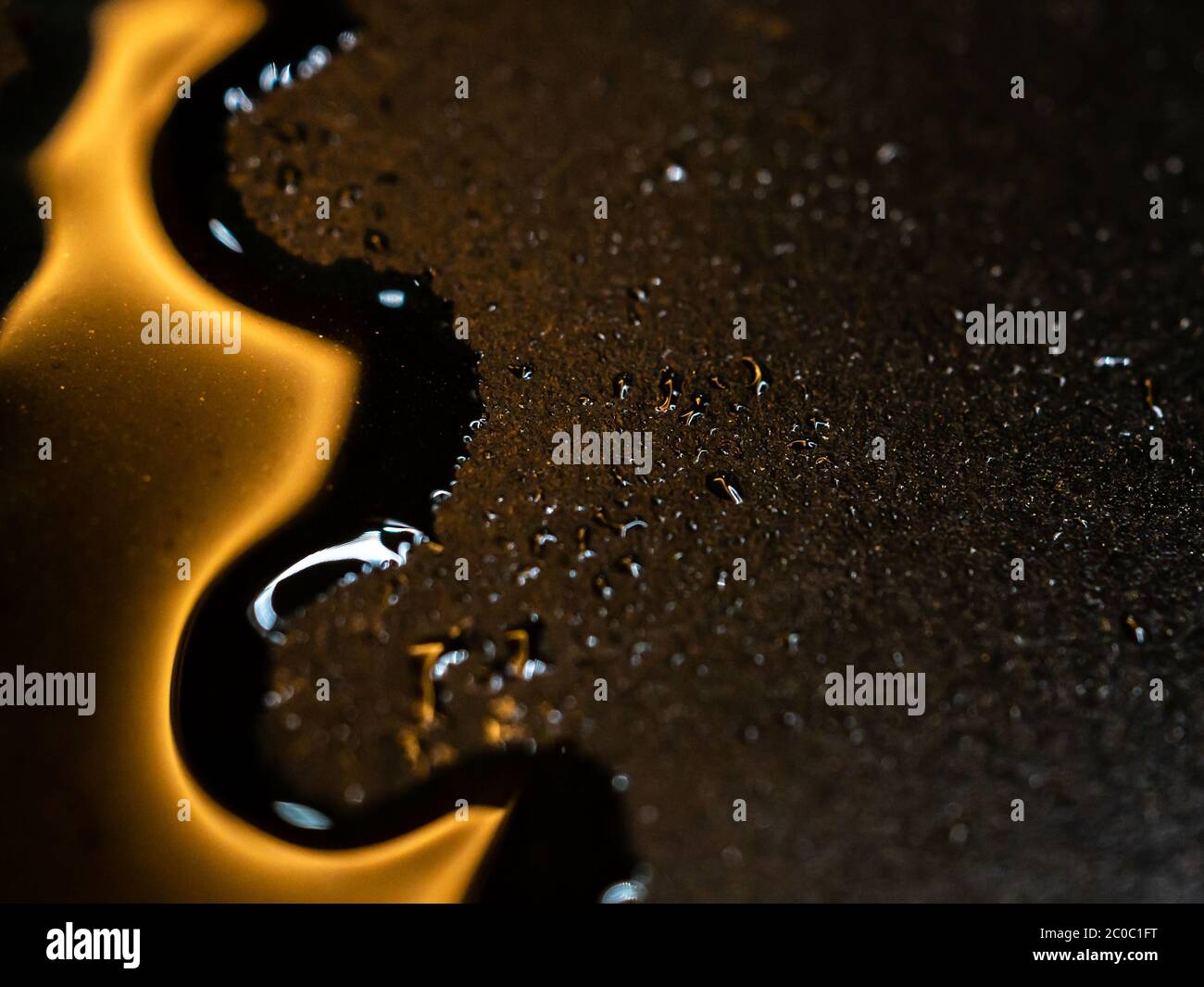 Selective focus on drops of hot oil on the surface of the pan. Abstract ...