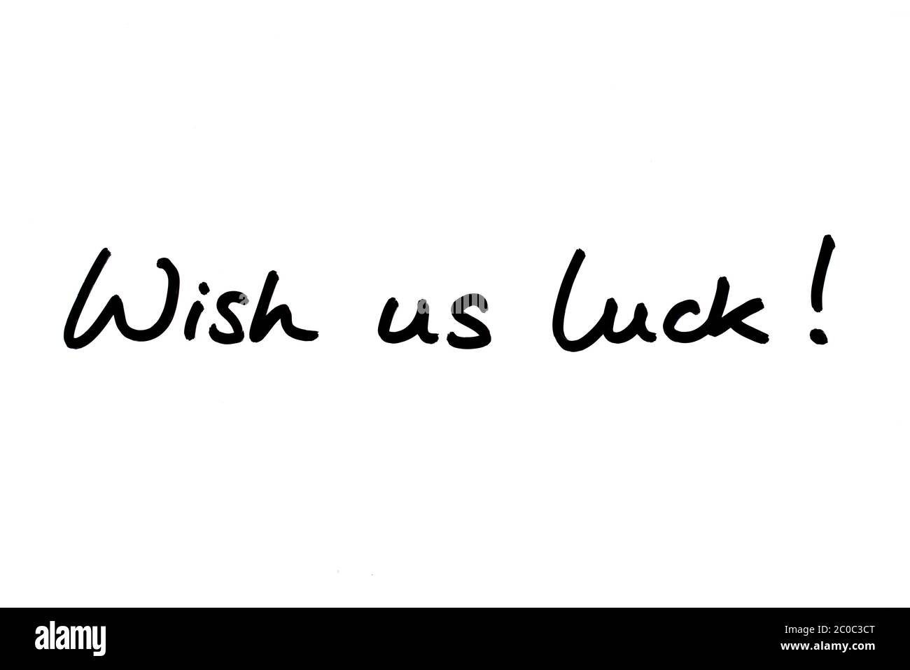 Wish us luck! handwritten on a white background Stock Photo - Alamy