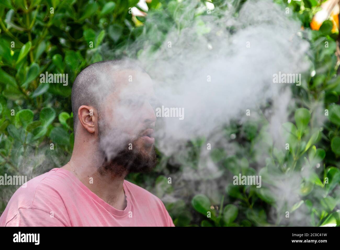 Bald and bearded man smoking Stock Photo - Alamy