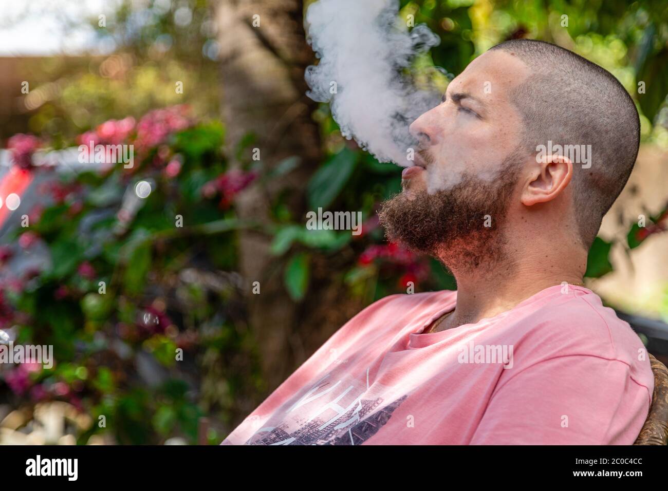 Bald and bearded man smoking Stock Photo - Alamy