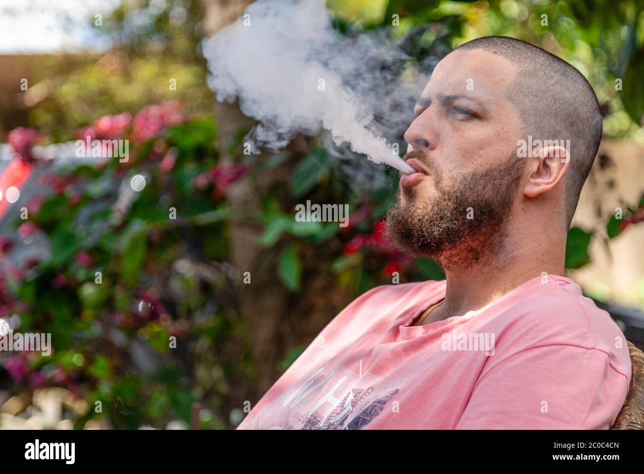 Bald and bearded man smoking Stock Photo - Alamy