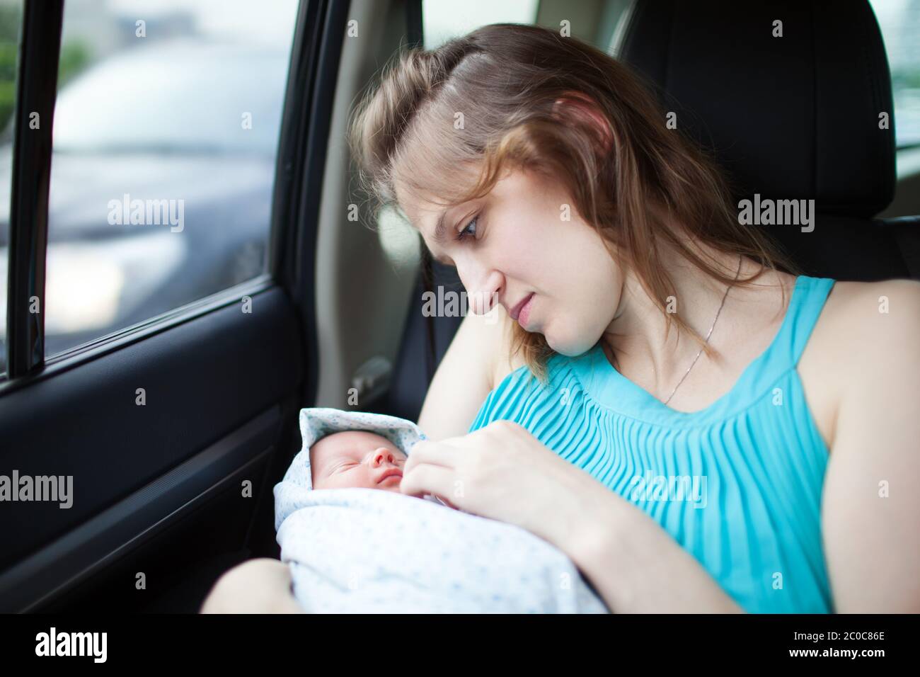 Mother with newborn in the car Stock Photo - Alamy