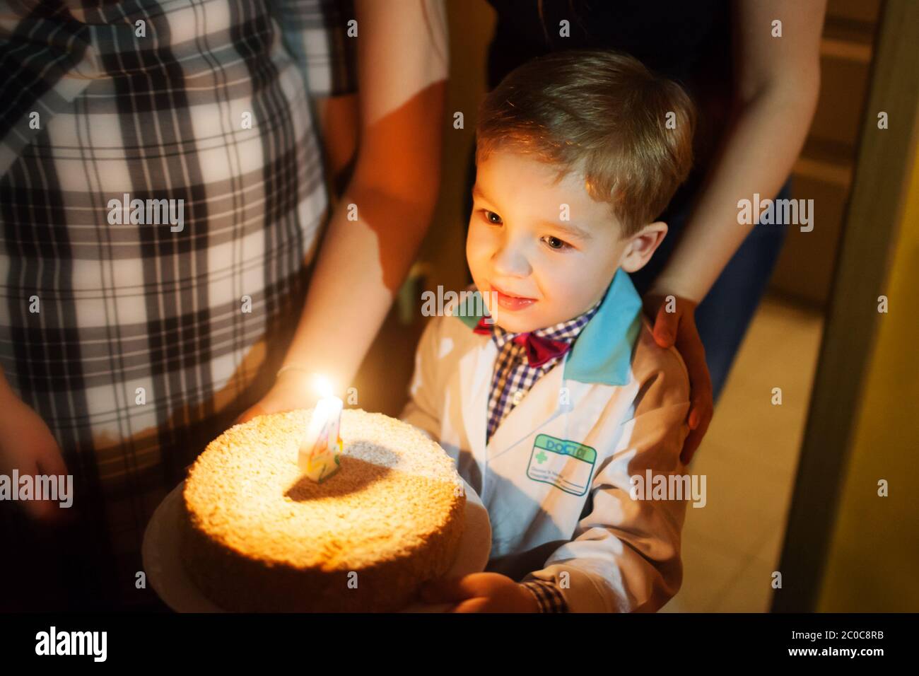 Little boy carrying birthday cake Stock Photo - Alamy