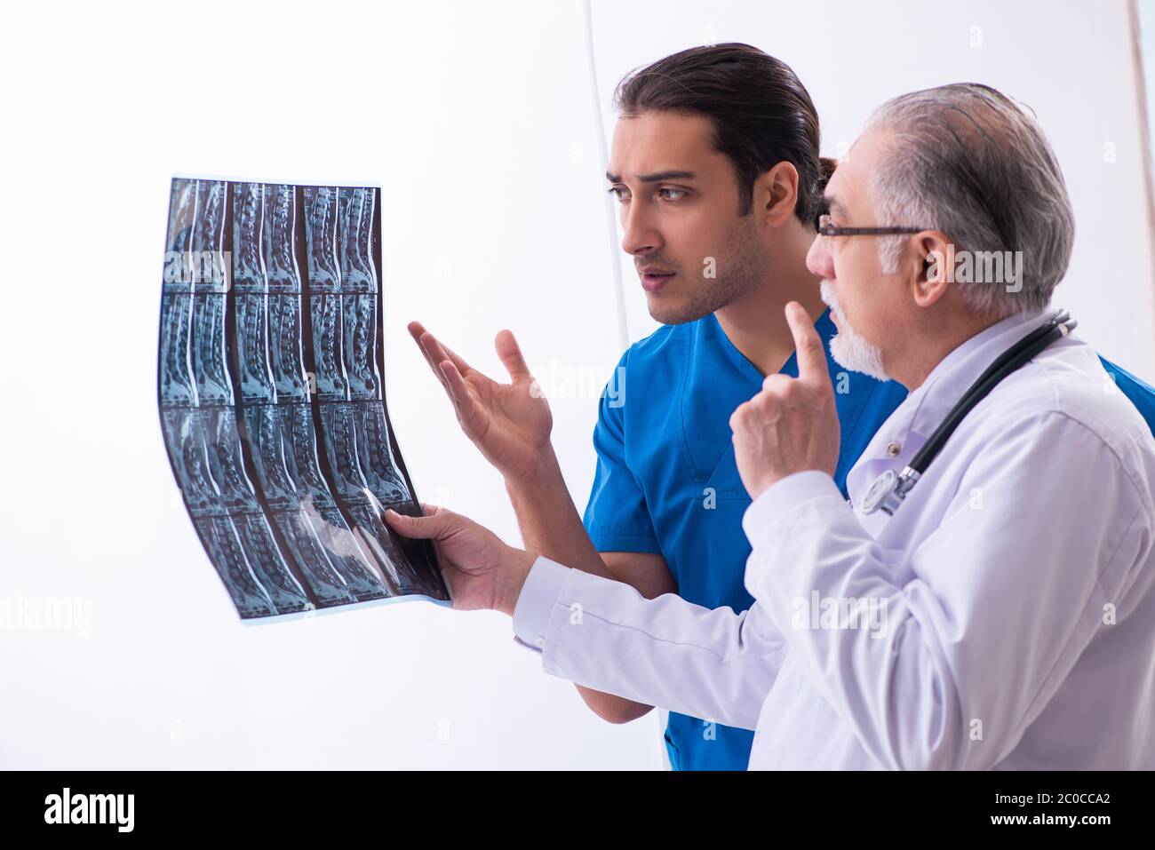 Two male doctors working in the modern clinic Stock Photo - Alamy