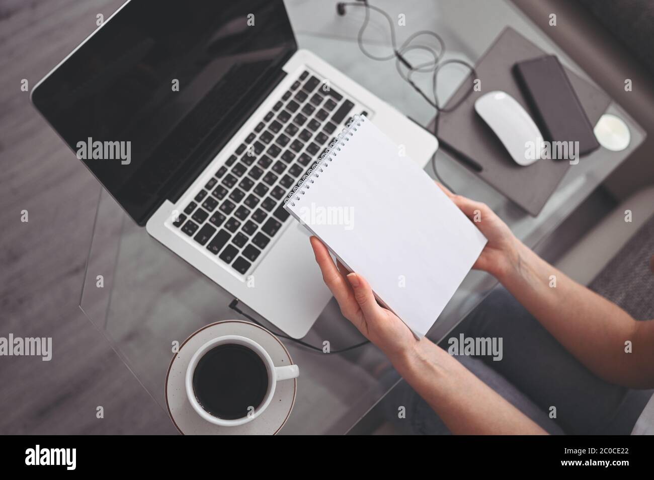 Unrecognizable woman hands writing in empty mock up notebook and ...