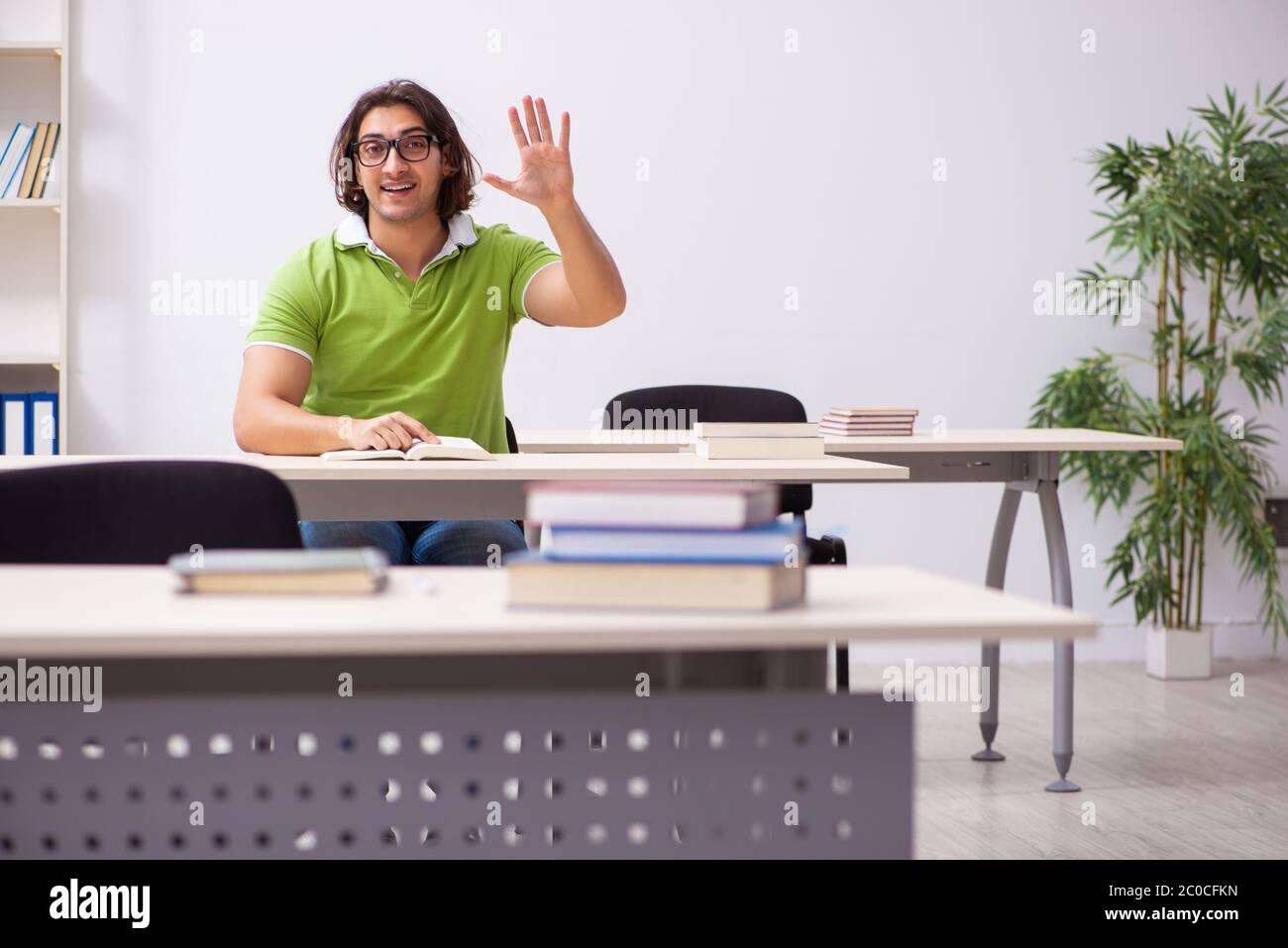Excited young college student waving hi-res stock photography and ...